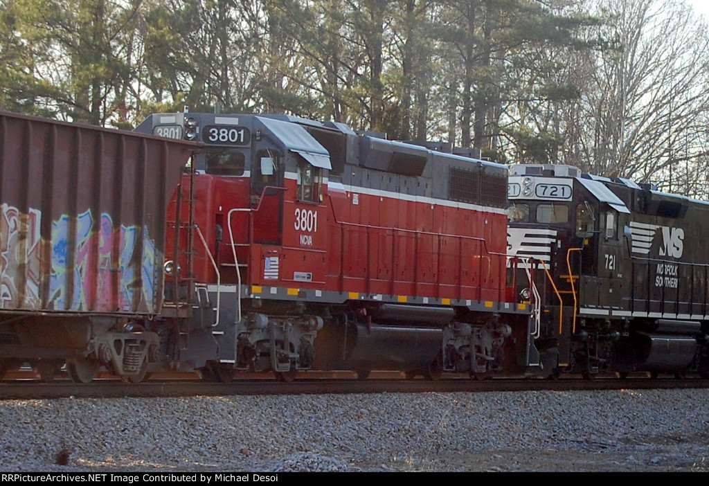 NCVA GP-38-2 #3801 is last out on a westbound multi unit lashup that ha just crossed Rives Rd.